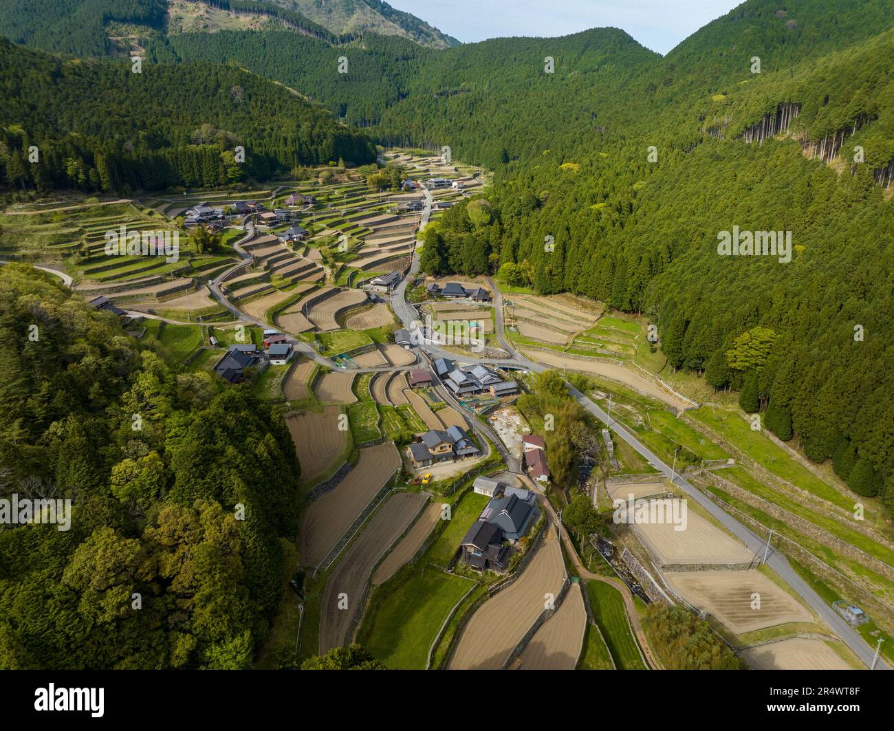 Aerial view of plowed terraced fields in traditional mountain village ...
