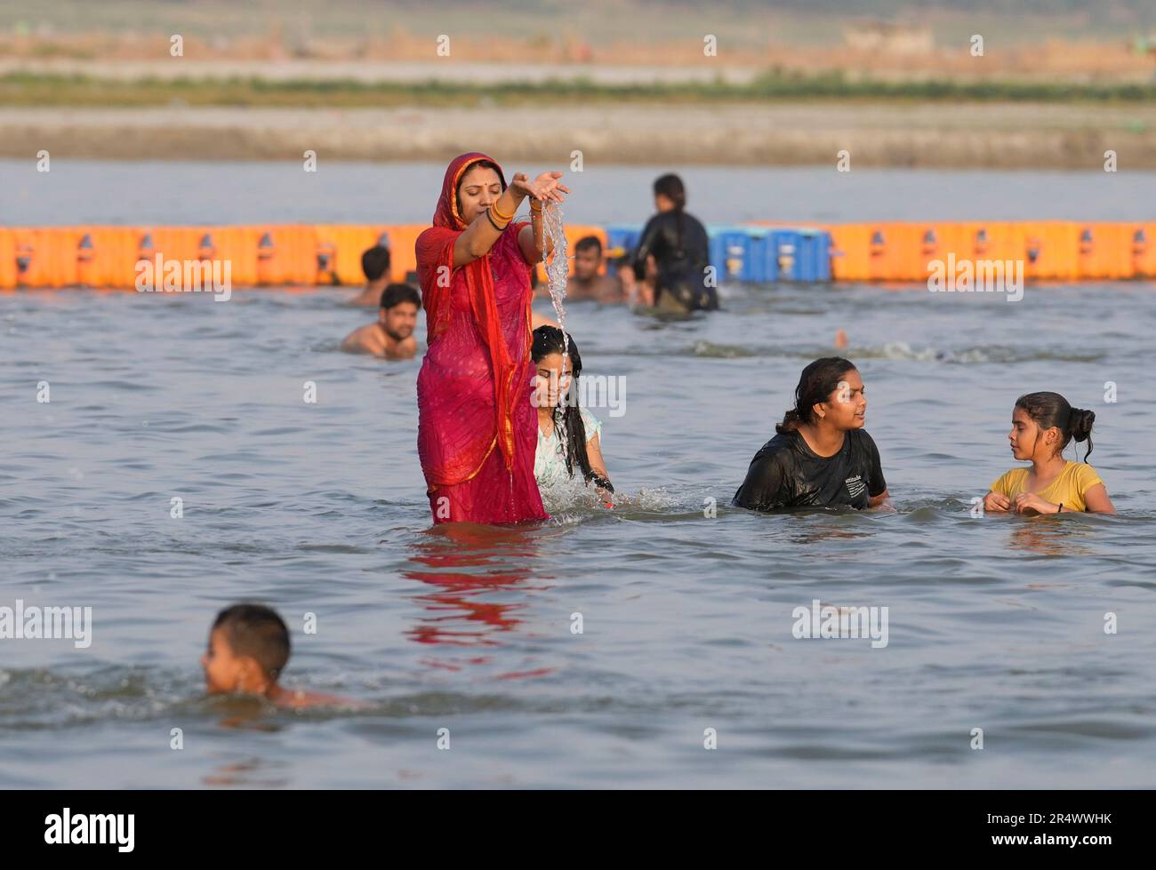 A devotee offers prayers in the River Ganges on Ganga Dussehra festival ...