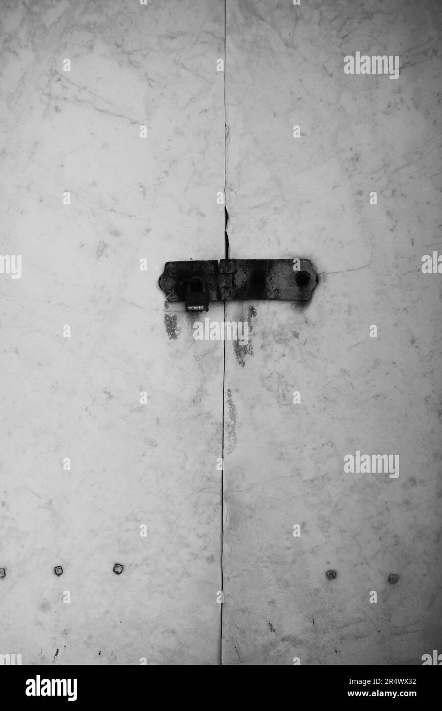 A vintage decorative latch holding a wall together in a black and white ...