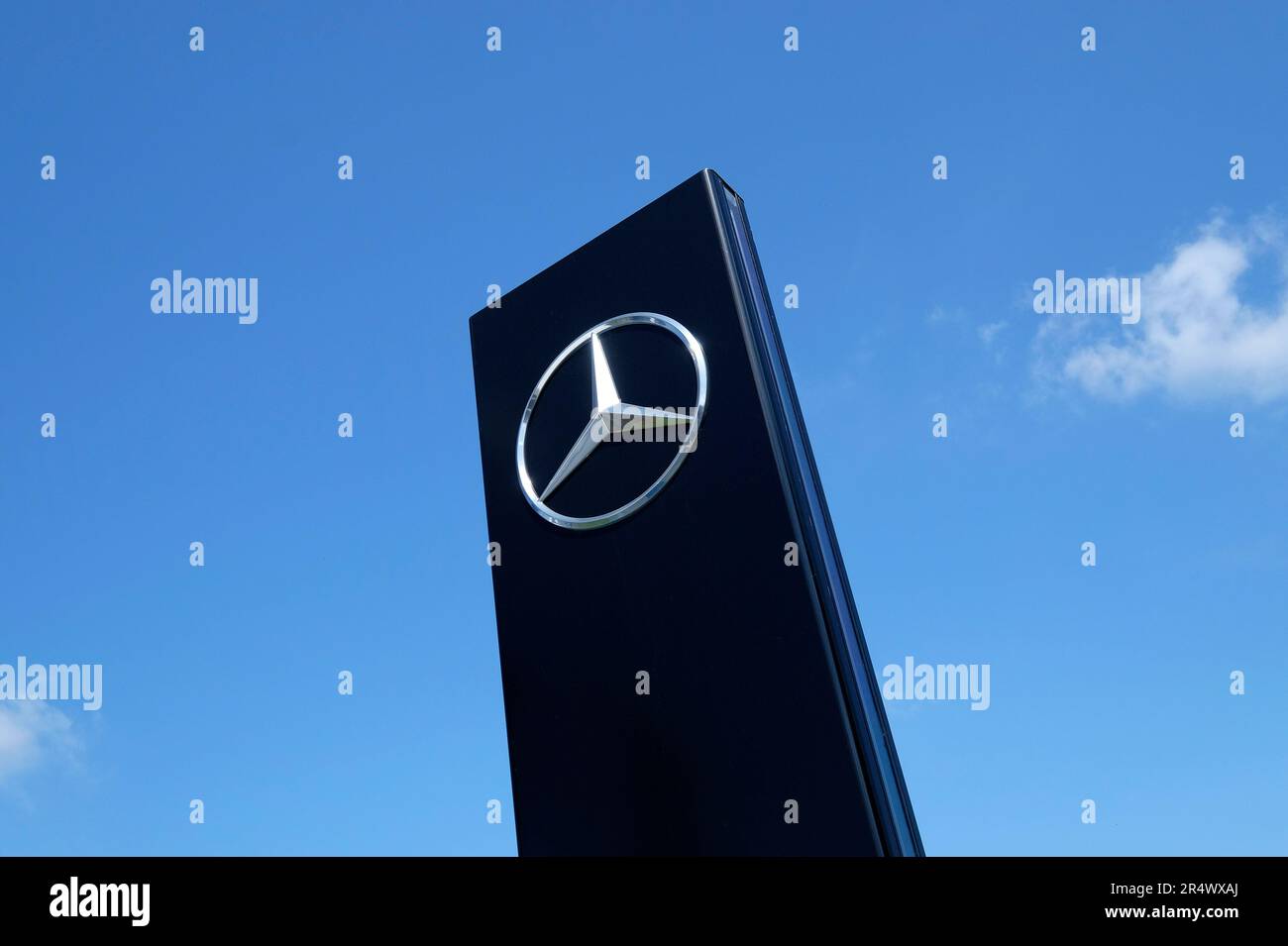 black mercedes benz dealership sign on blue sky background Stock Photo ...