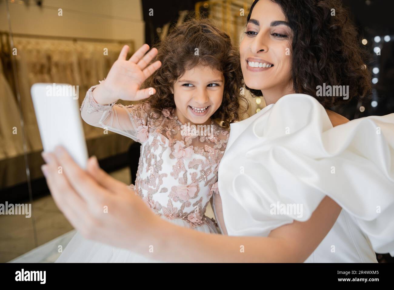 charming middle eastern bride with brunette hair in white wedding dress ...
