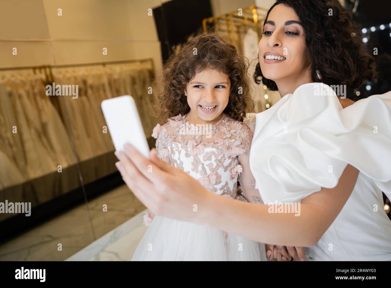charming middle eastern bride with brunette hair in white wedding dress ...