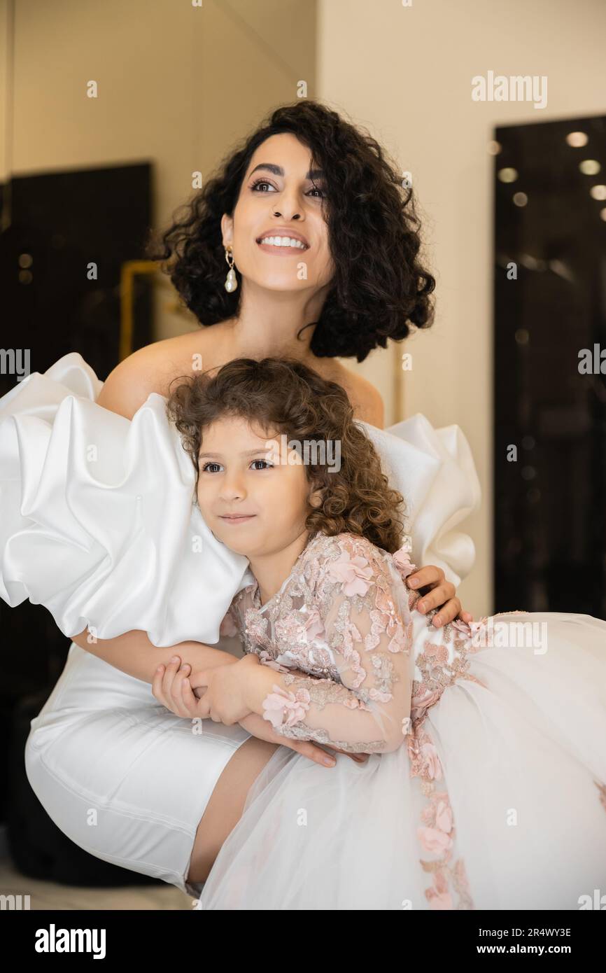 charming middle eastern bride with brunette hair in white wedding dress ...