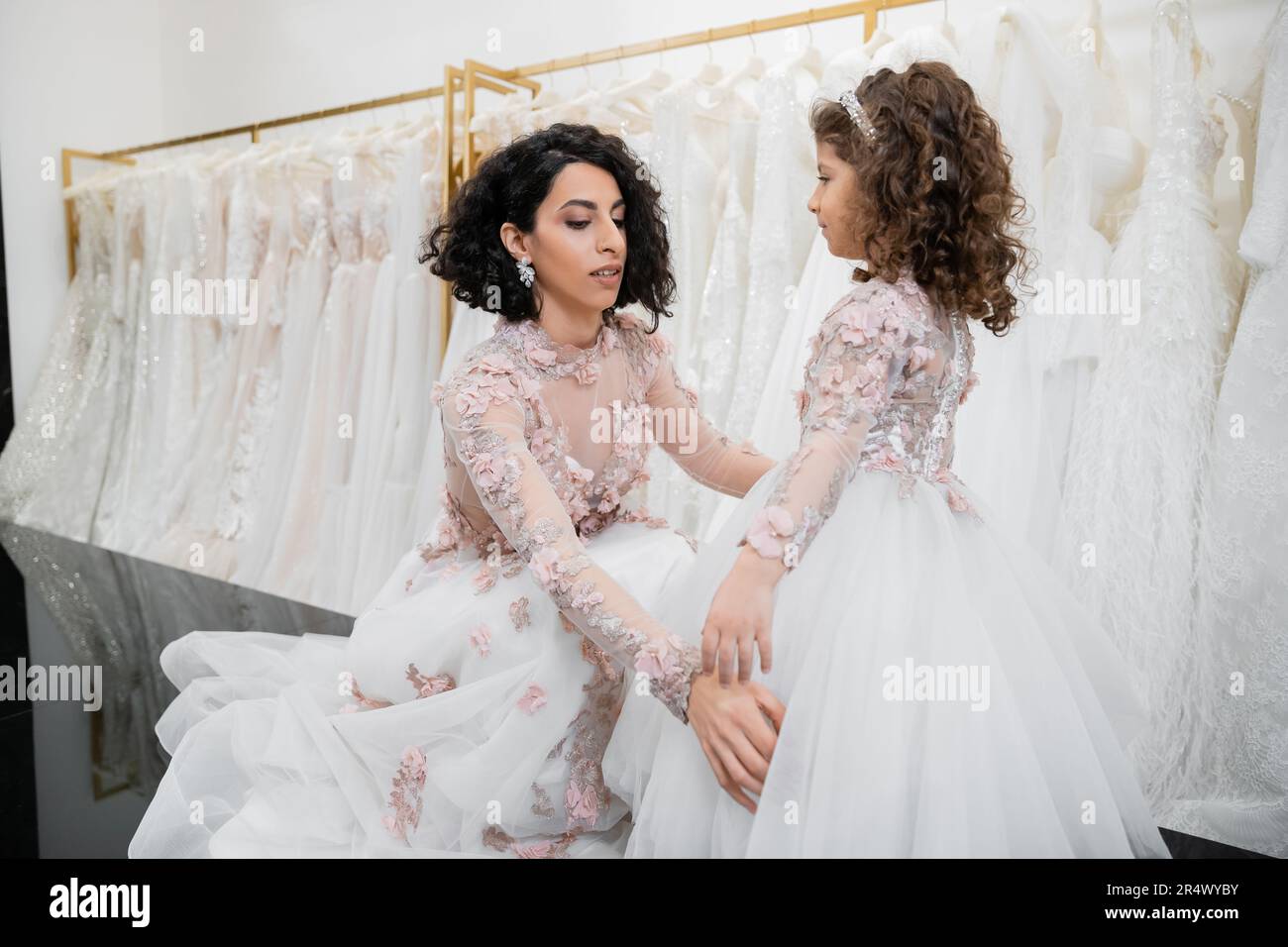 special moment, brunette middle eastern bride in floral wedding gown ...