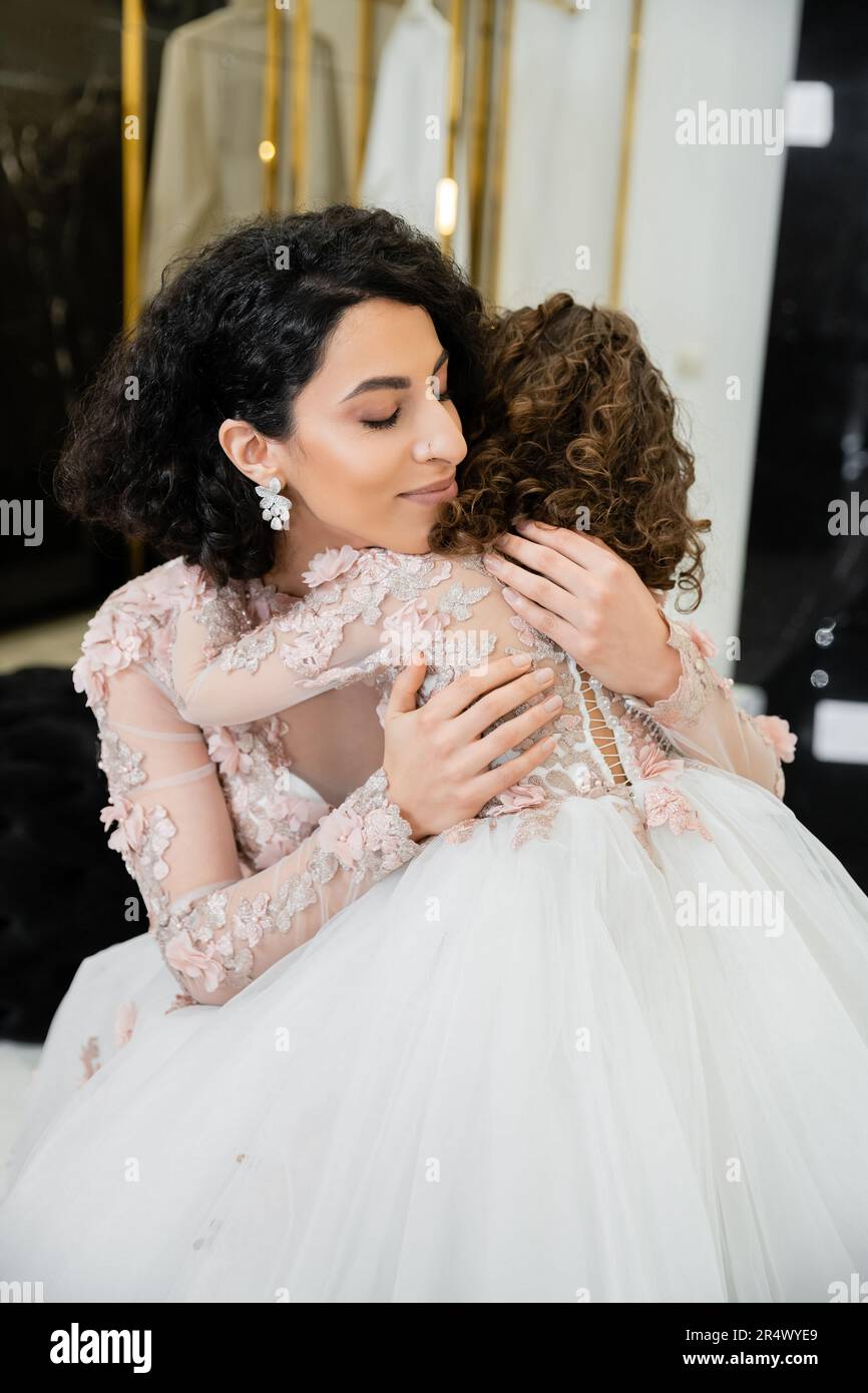 charming middle eastern bride with wavy hair in stunning wedding dress ...