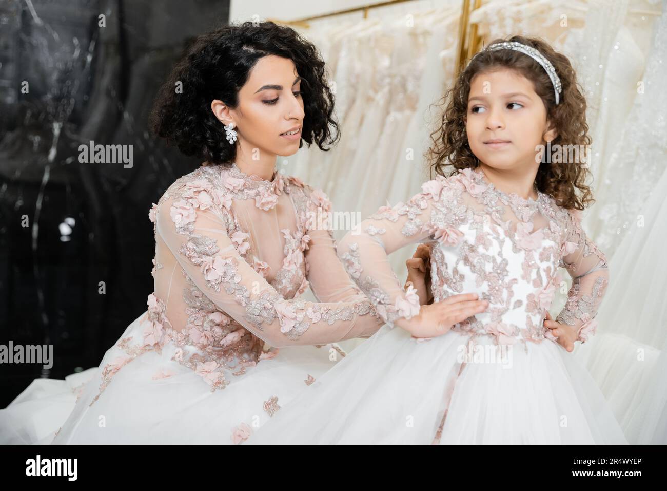 alluring middle eastern bride with brunette wavy hair in wedding dress ...