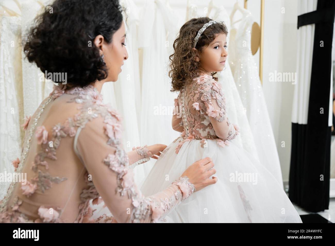 middle eastern bride with brunette wavy hair in floral wedding dress ...