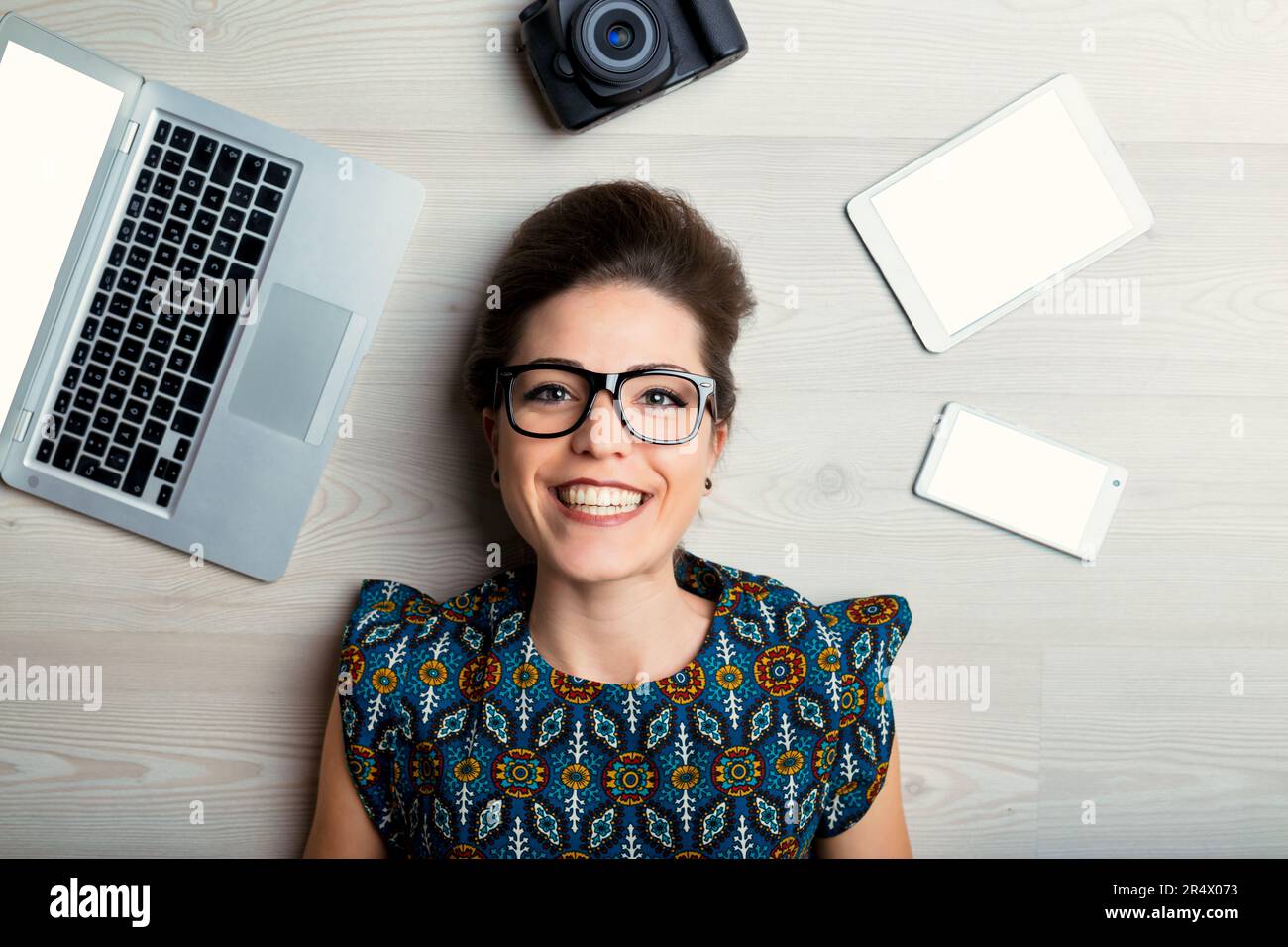 Young woman surrounded by tech and cameras: Today's image culture is ...