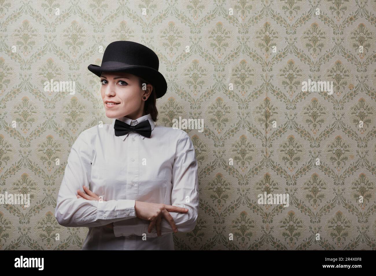 Against a retro yellow-green backdrop, a young woman dons a white shirt ...