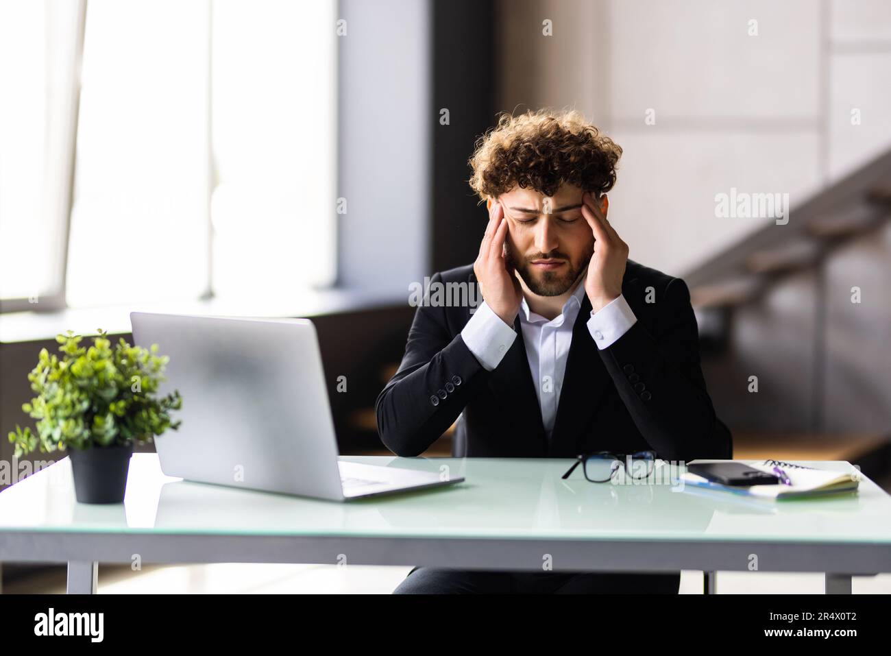 Tired exhausted arabic or indian man, office worker, manager or ...