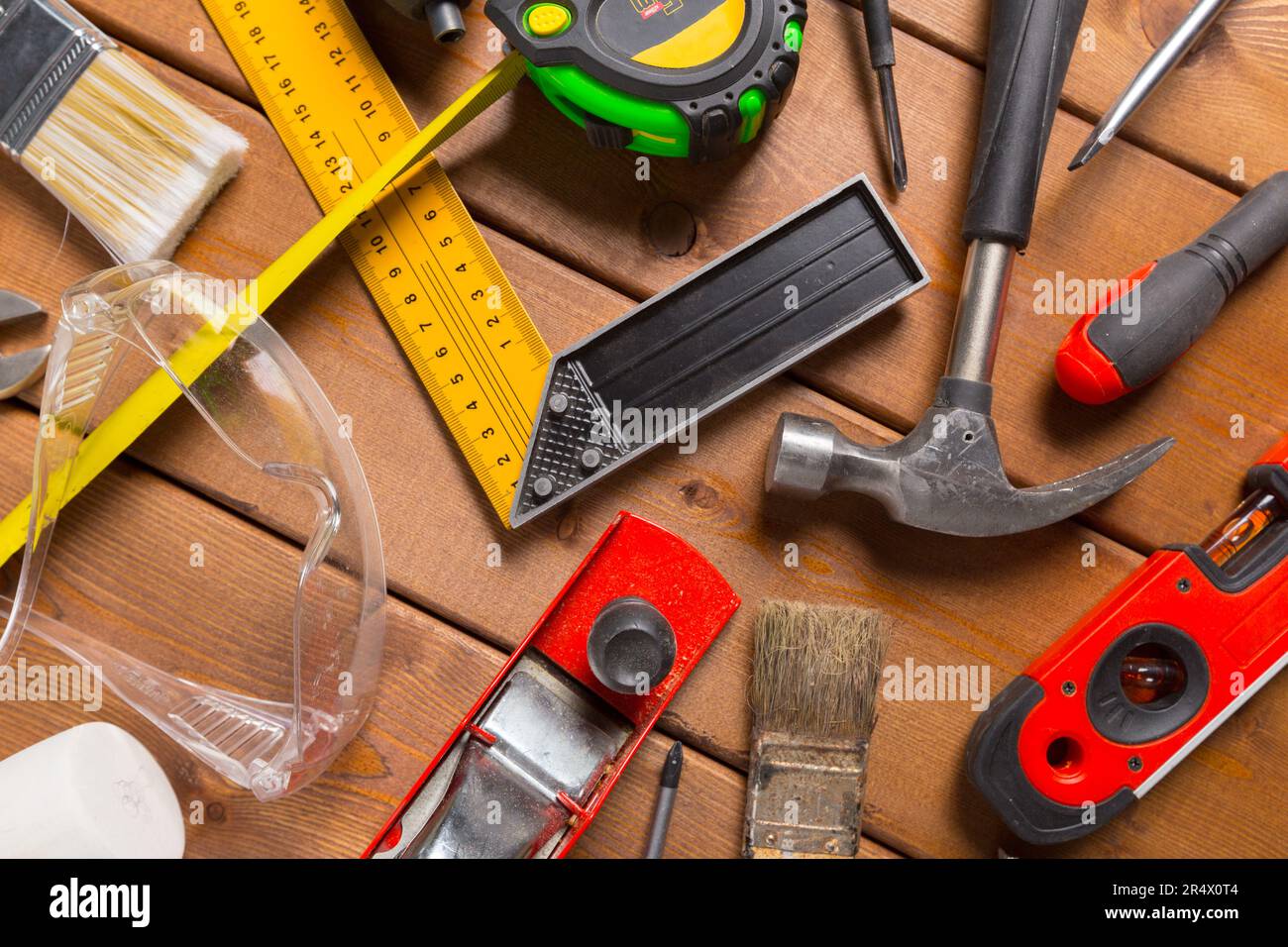 Assorted work tools on wood background Stock Photo - Alamy