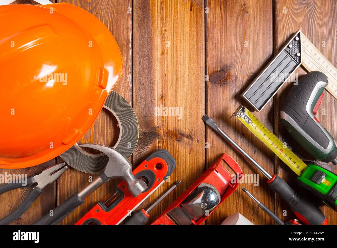 Assorted work tools on wood background Stock Photo - Alamy