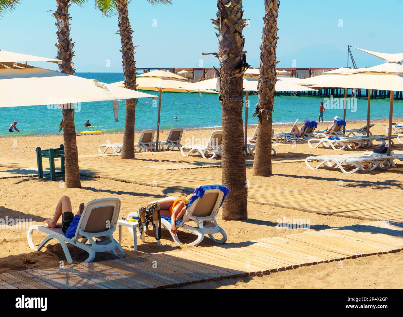 Antalya; Turkey-September 10; 2022: Tourist couple resting on sunbeds ...