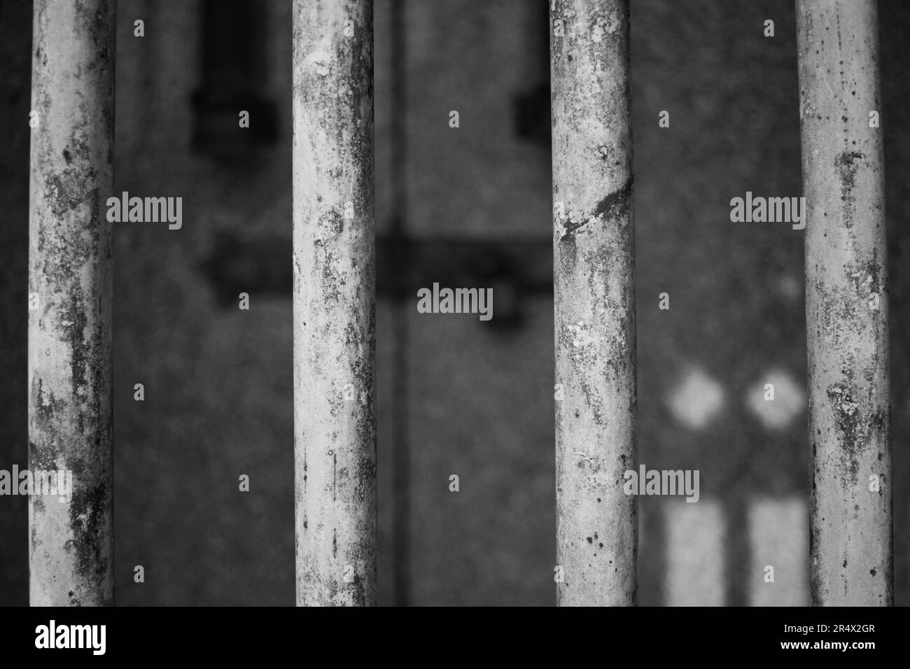 Vertical metal prison bars protecting the room inside in a black and ...