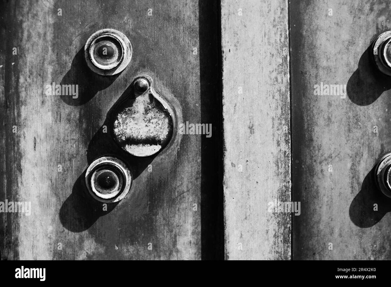 A fancy keyhole on a traditional medieval metal fence in a black and ...