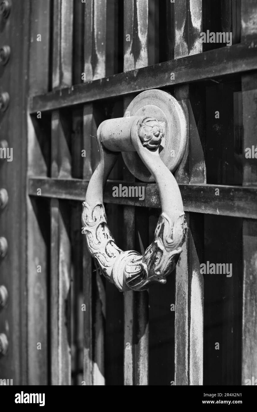 A traditional medieval metal door knocker in a black and white Stock ...