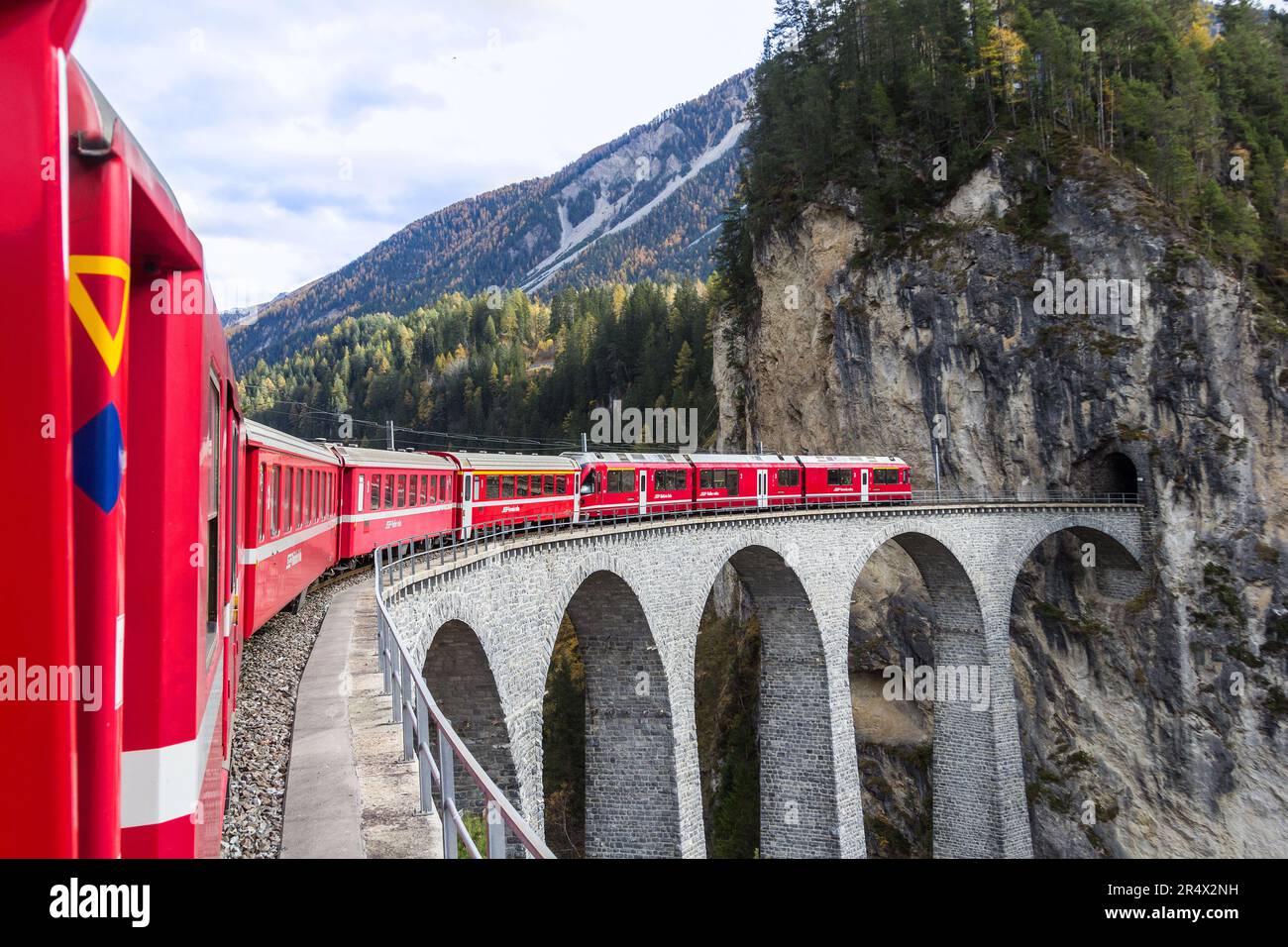 Filisur Switzerland - October 31. 2021: A red passenger train from the ...