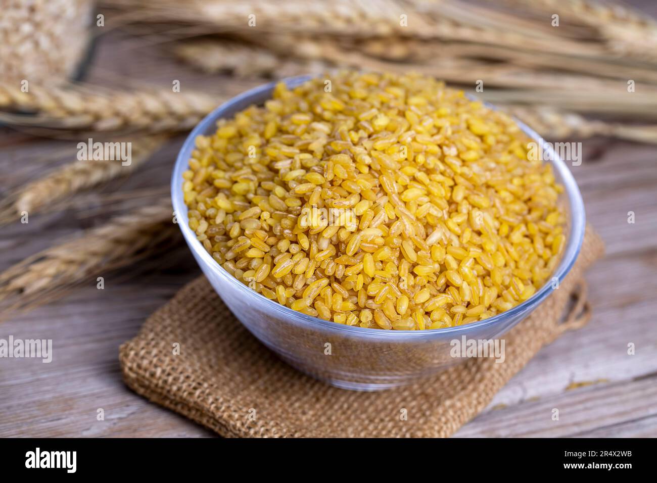 Dry raw bulgur in a glass bowl Stock Photo - Alamy