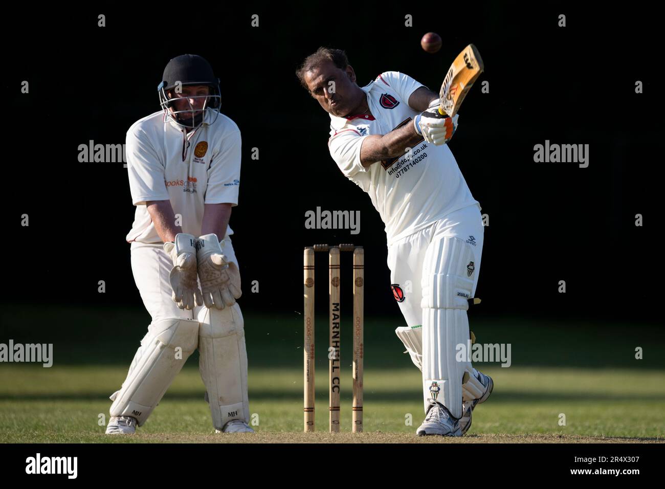 Cricket batsman hitting four runs Stock Photo - Alamy