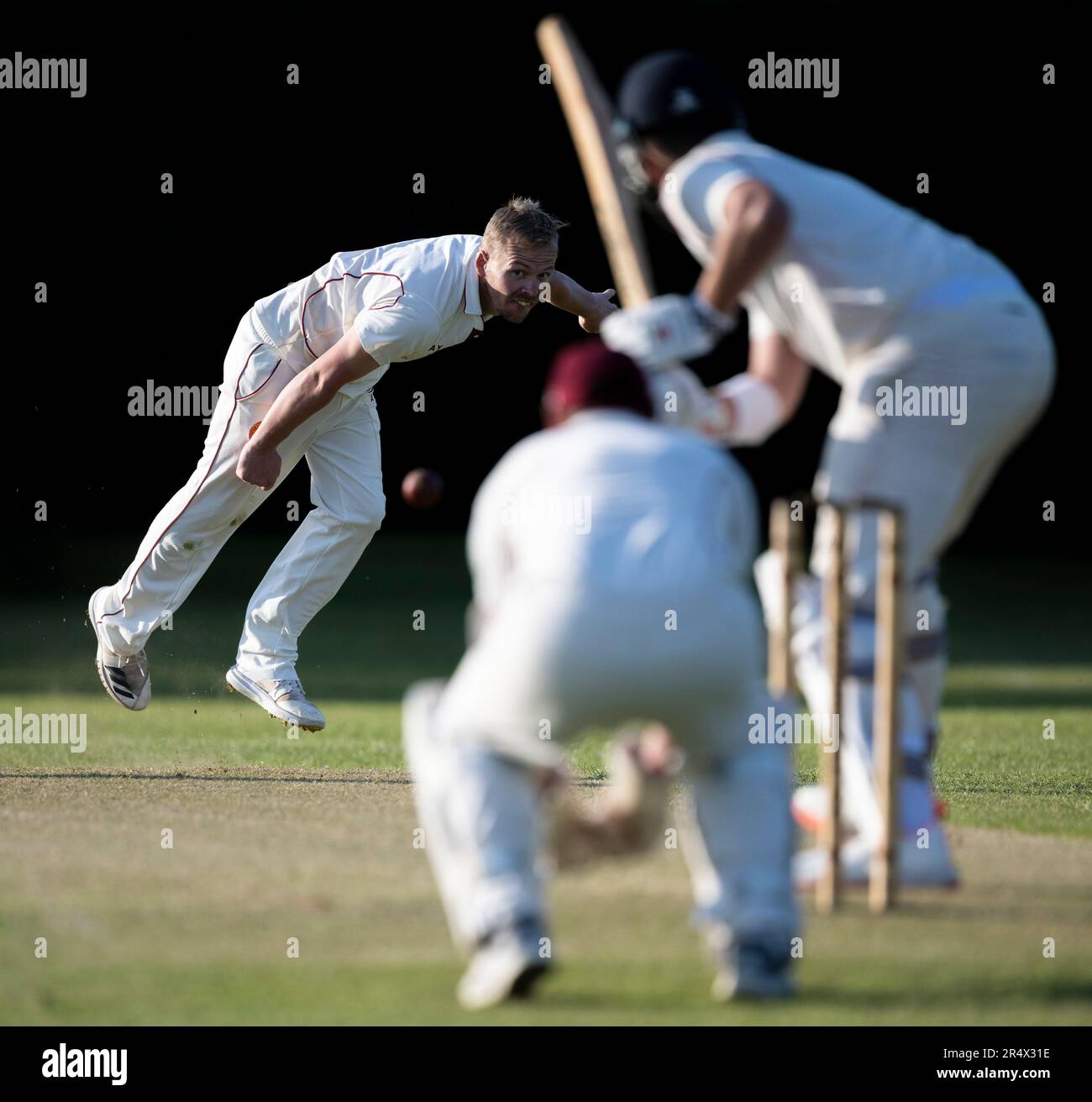 Cricket bowler in action Stock Photo - Alamy