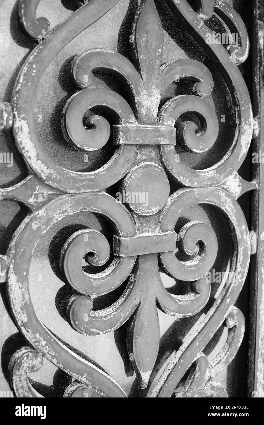 Decorative copper metal gate with lots of swirls in a black and white ...