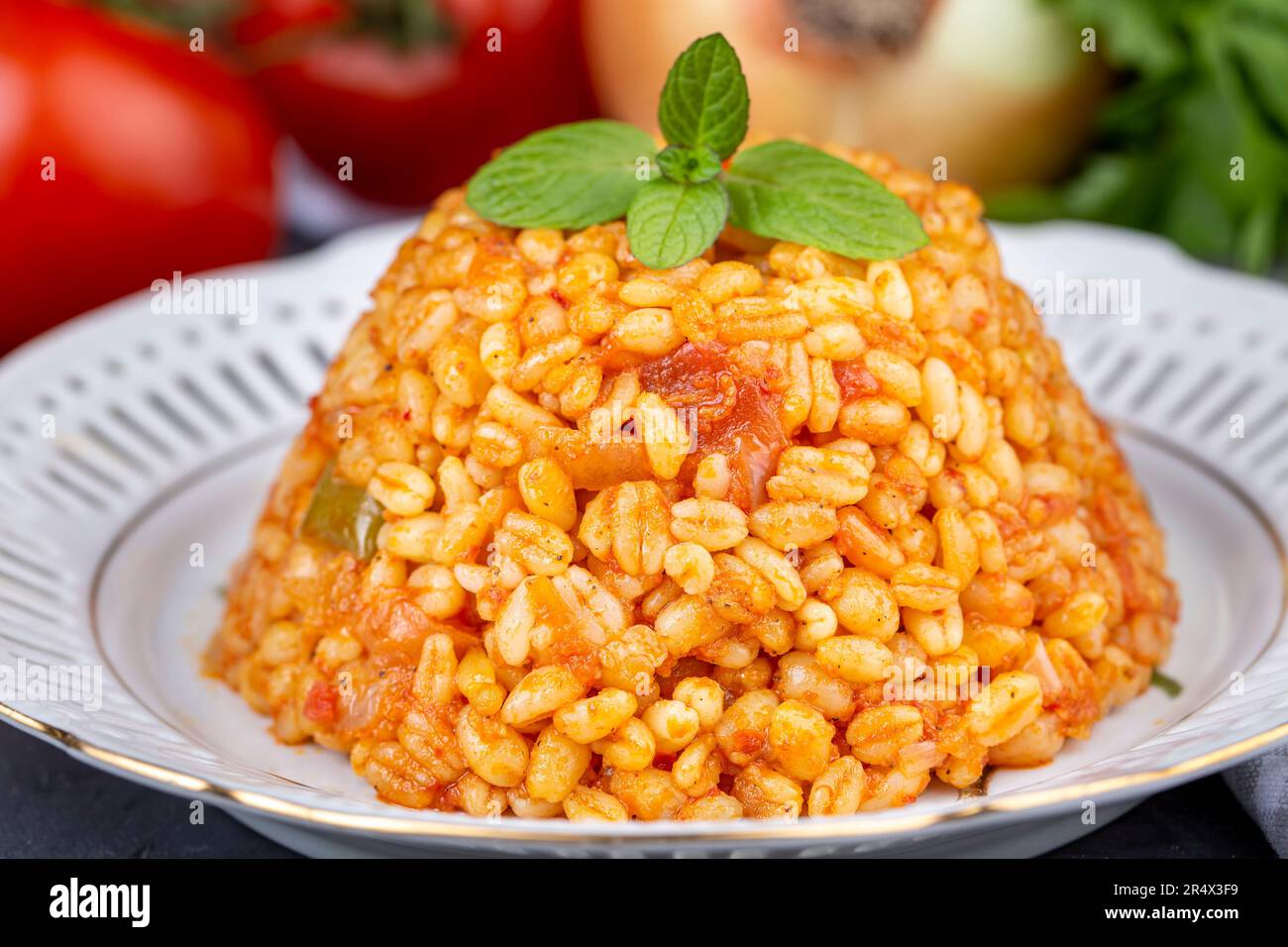 Traditional turkish bulgur pilaf with tomato sause in plate (Turkish ...