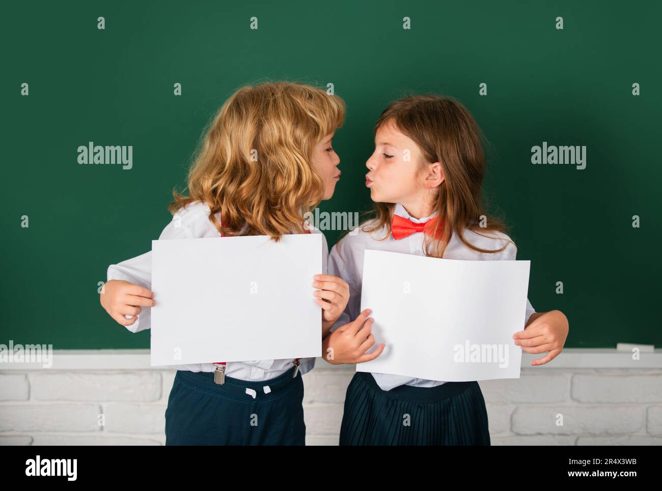 Kids love, first kiss. Back to school. Schoolchild friends back to ...