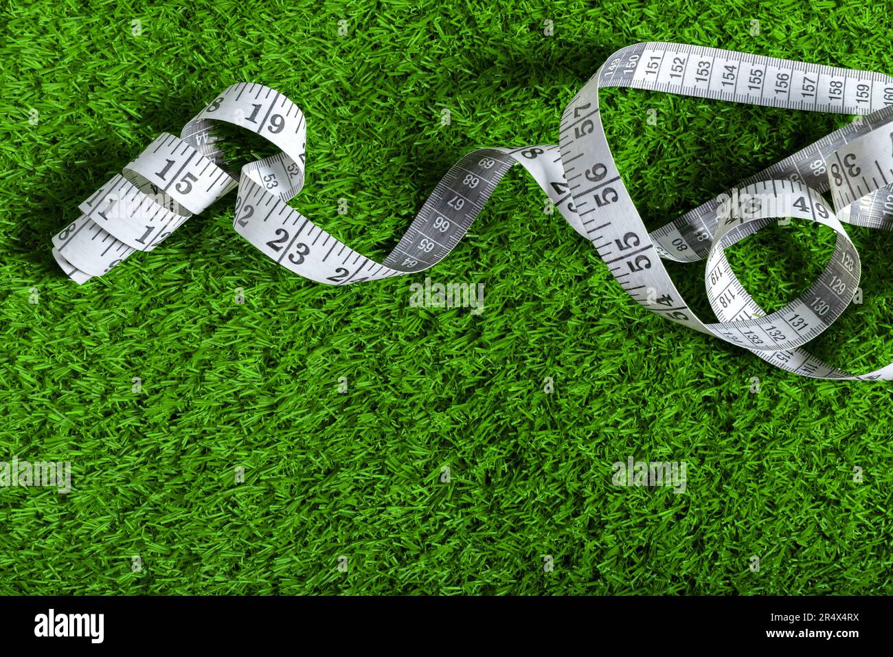 Measuring Tape on the grass Stock Photo - Alamy