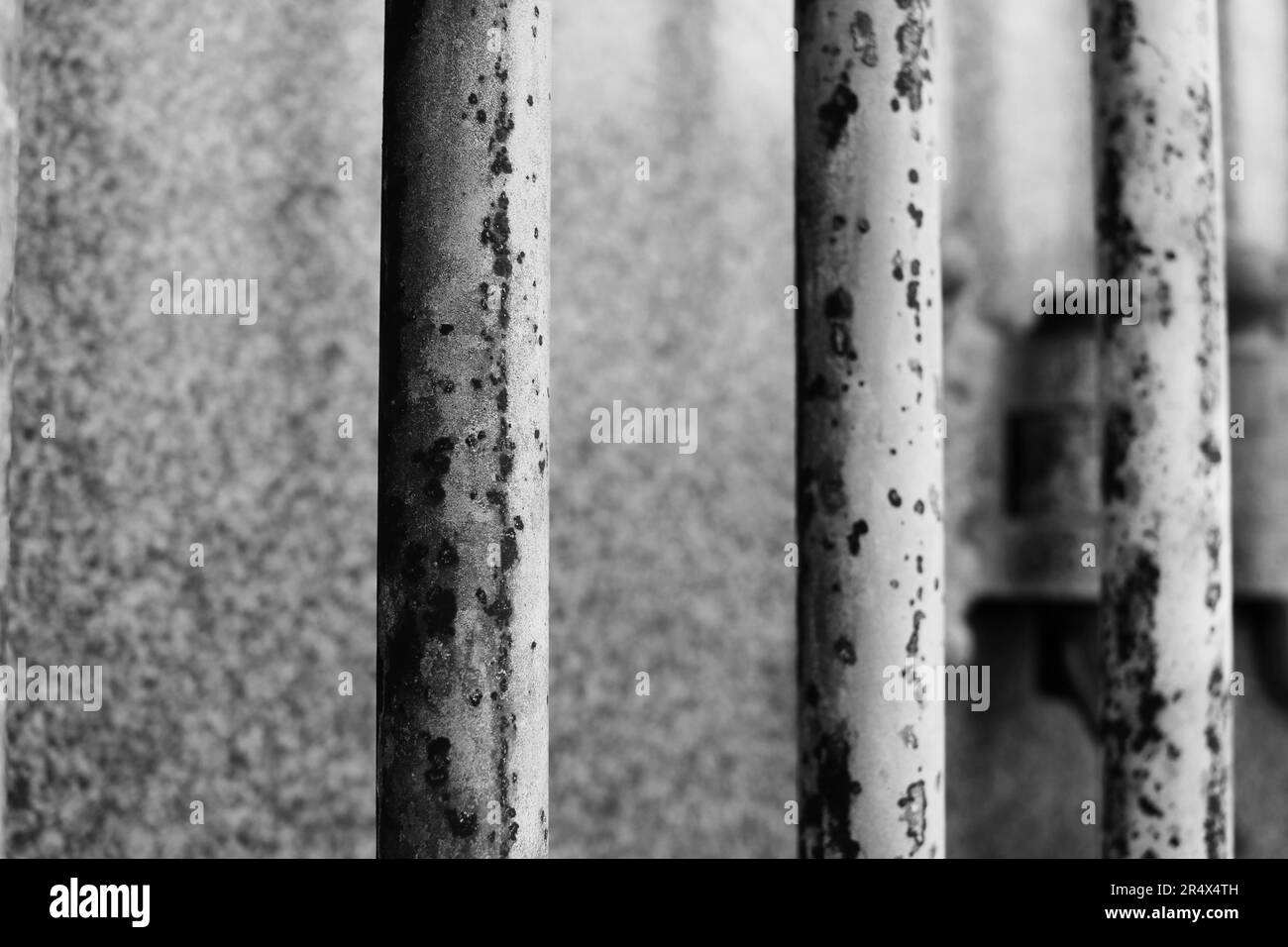 Vertical metal prison bars protecting the room inside in a black and ...