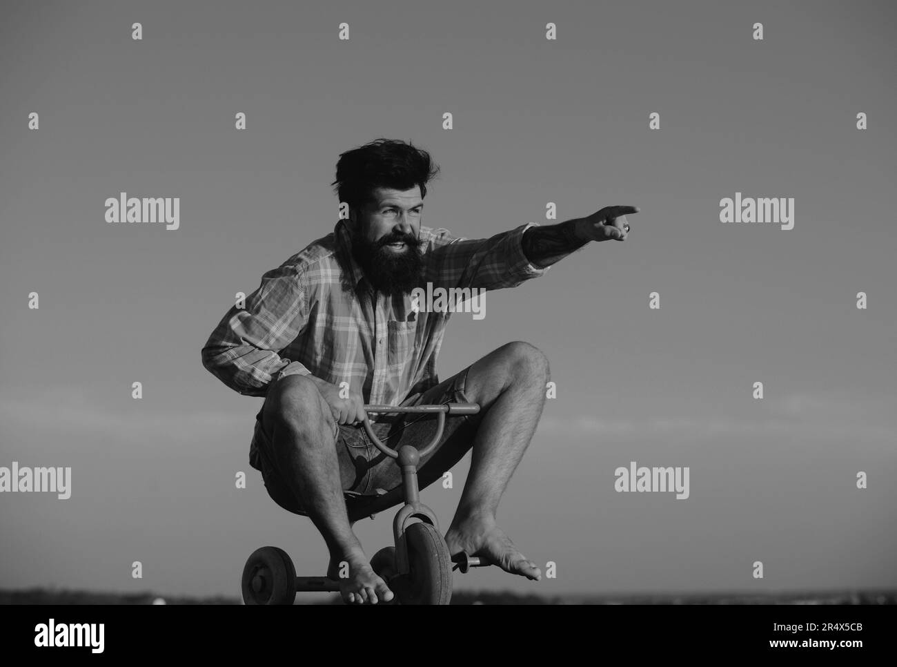 Crazy man riding a small bicycle. Funny man riding a bike Stock Photo ...