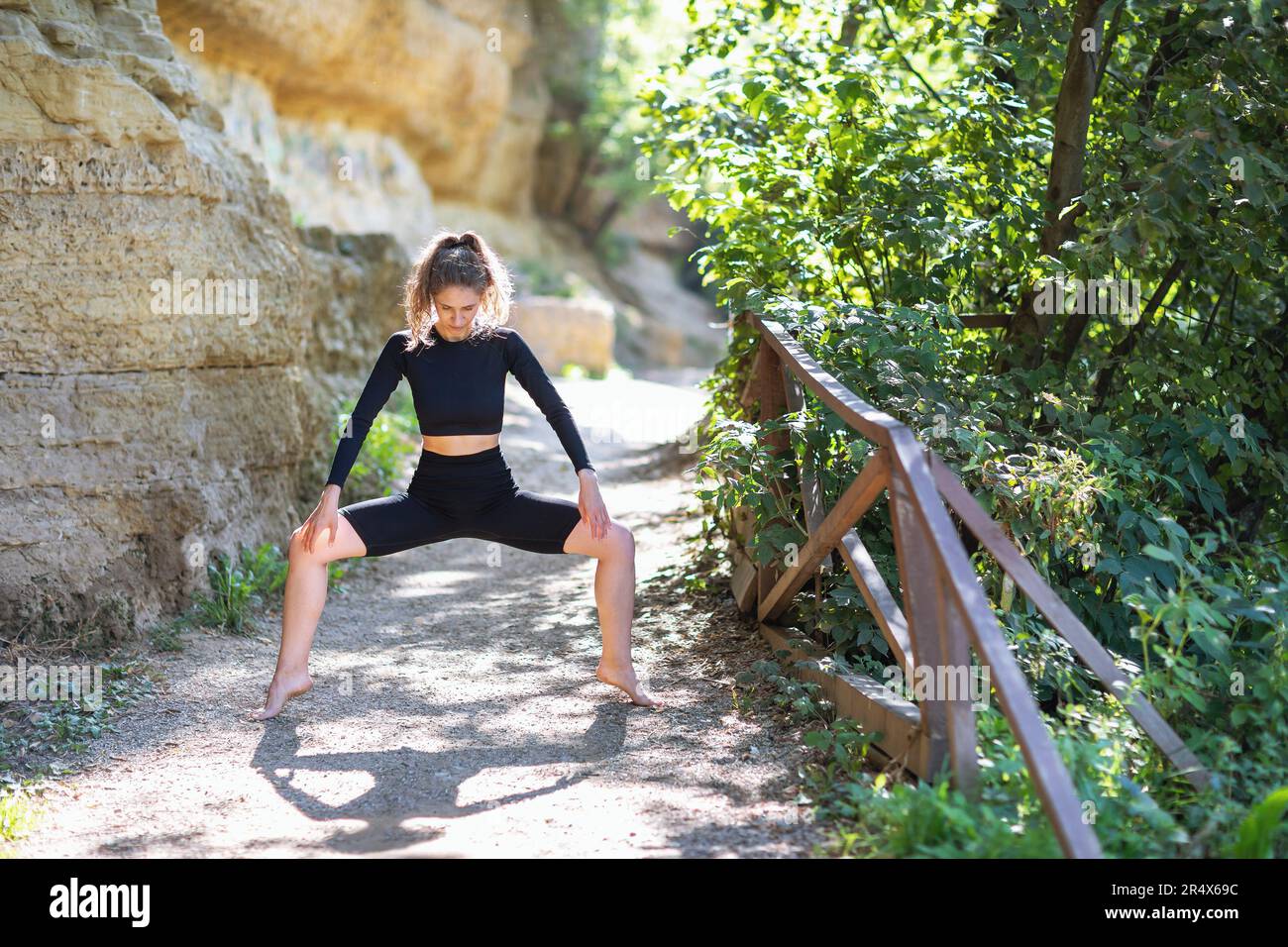 Young woman leading a healthy lifestyle and practicing yoga, doing a ...