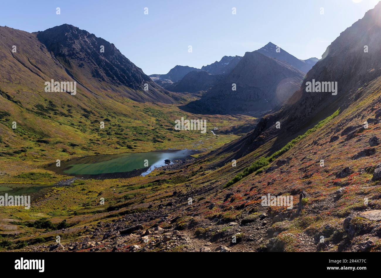 Autumn view of an alpine lake surrounded by the Chugach Mountains along ...
