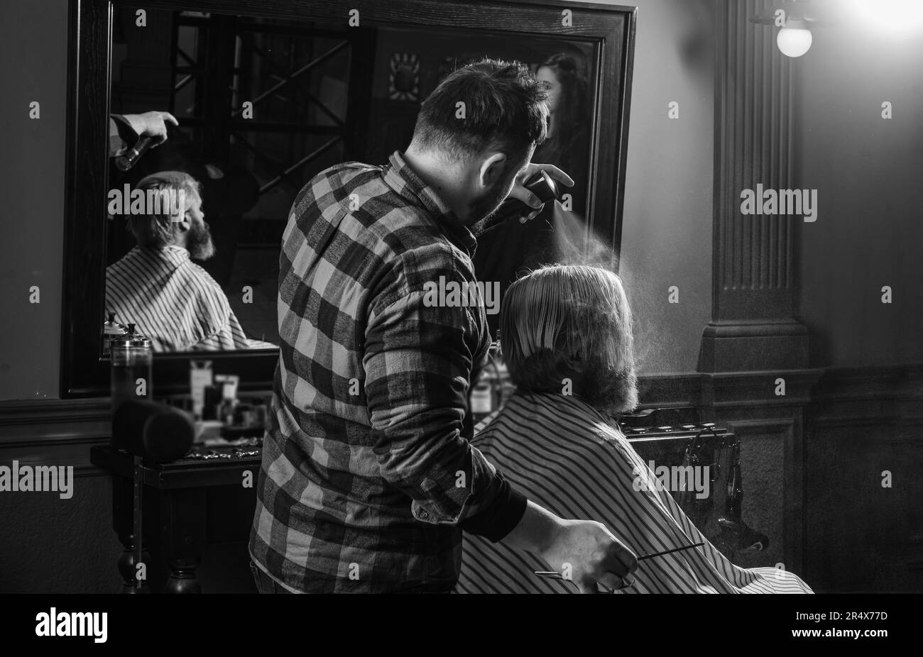 Following his personal style. master barber does the hairstyle and ...