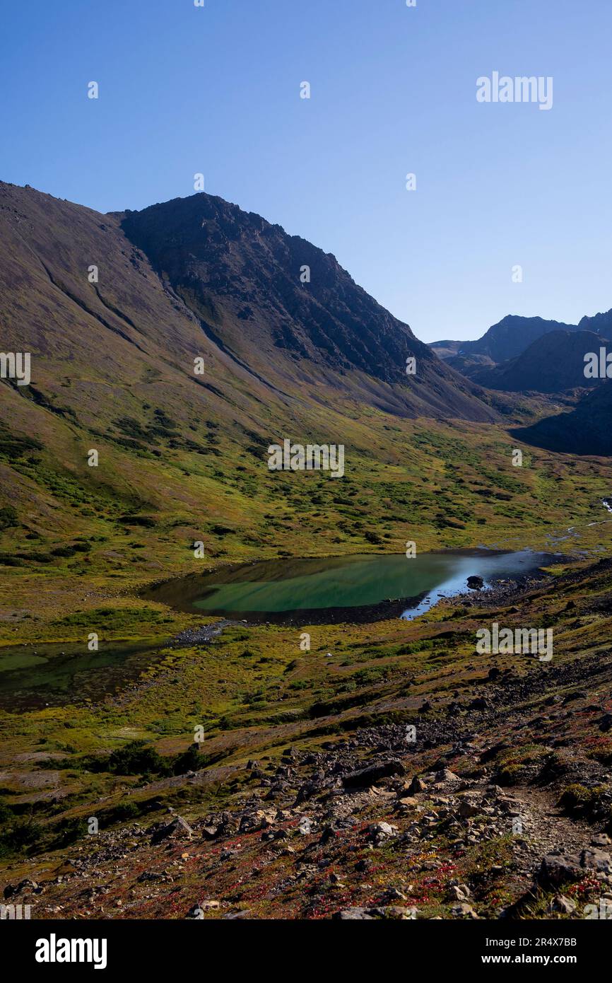 Autumn view of an alpine lake surrounded by the Chugach Mountains along ...