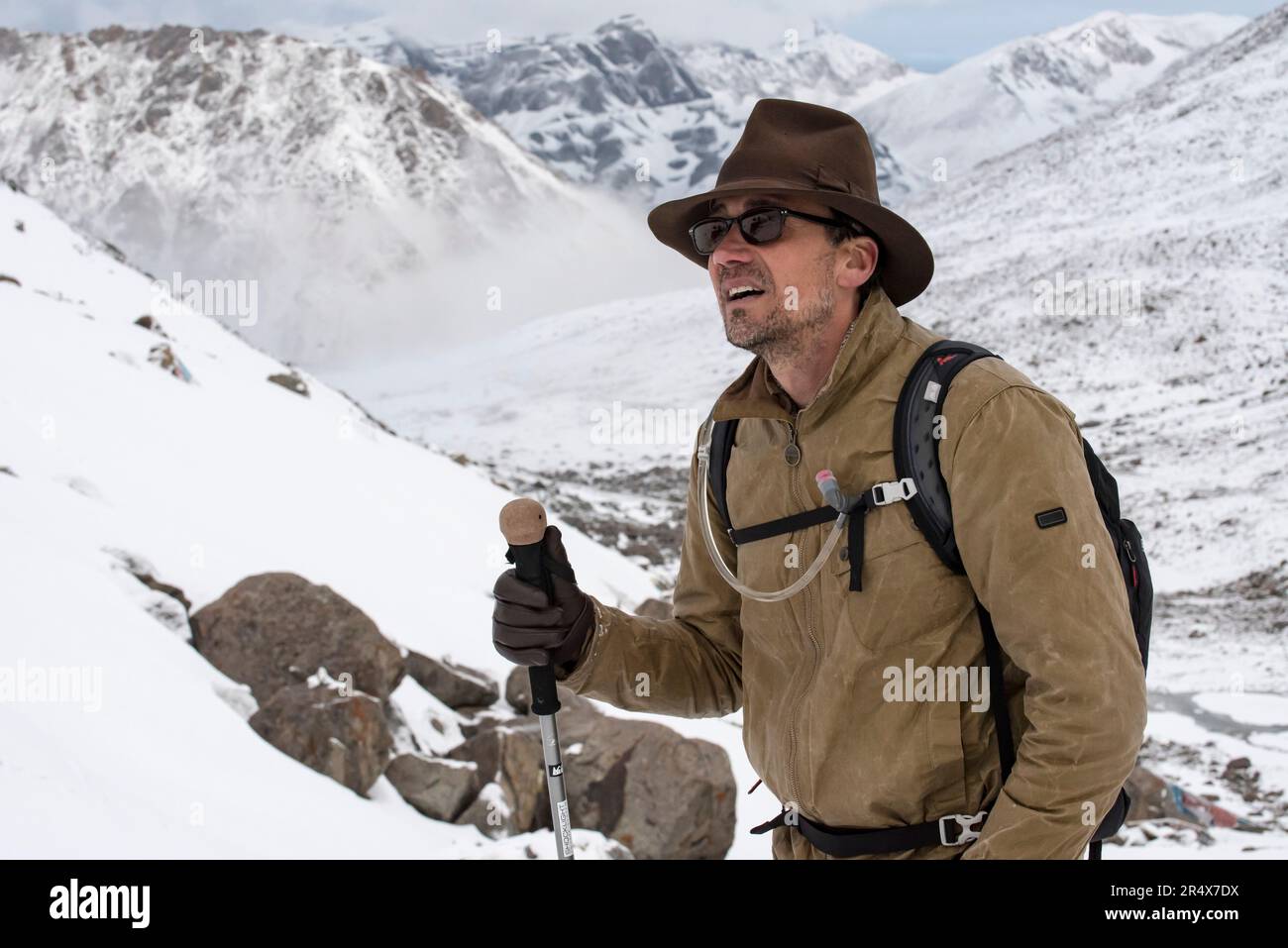 Portrait of trekker on the snow-covered mountainside of Mount Kailash ...
