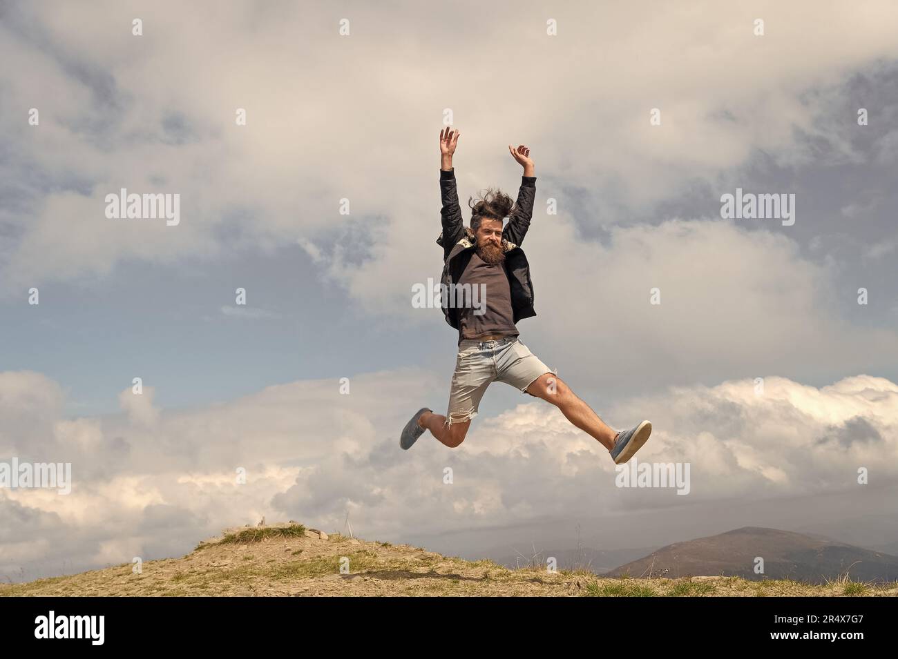 photo of jumping man in a mountain. jumping man outdoor. jumping man in ...