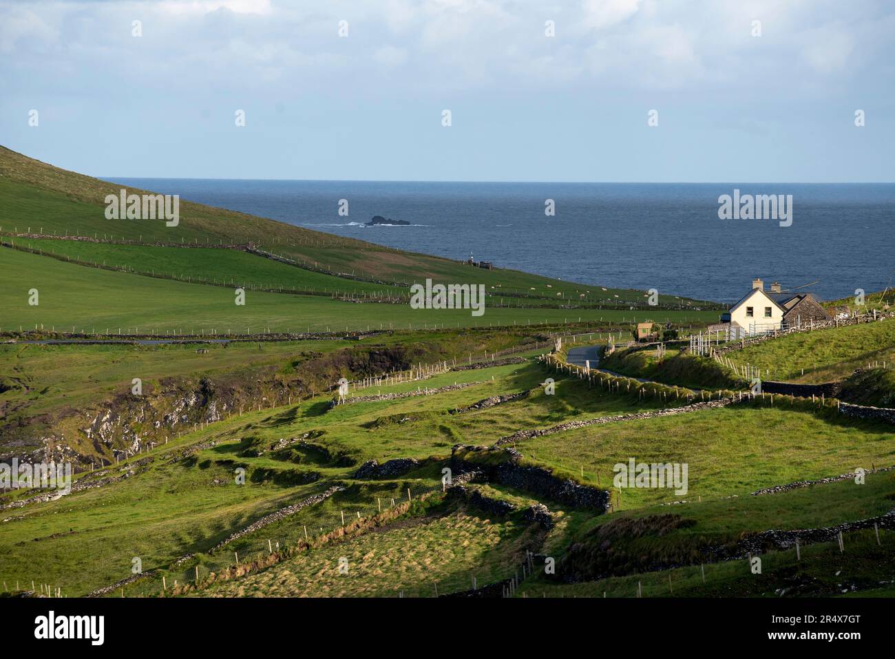 Traditional coastal cottage along the Atlantic shore on the Dingle ...