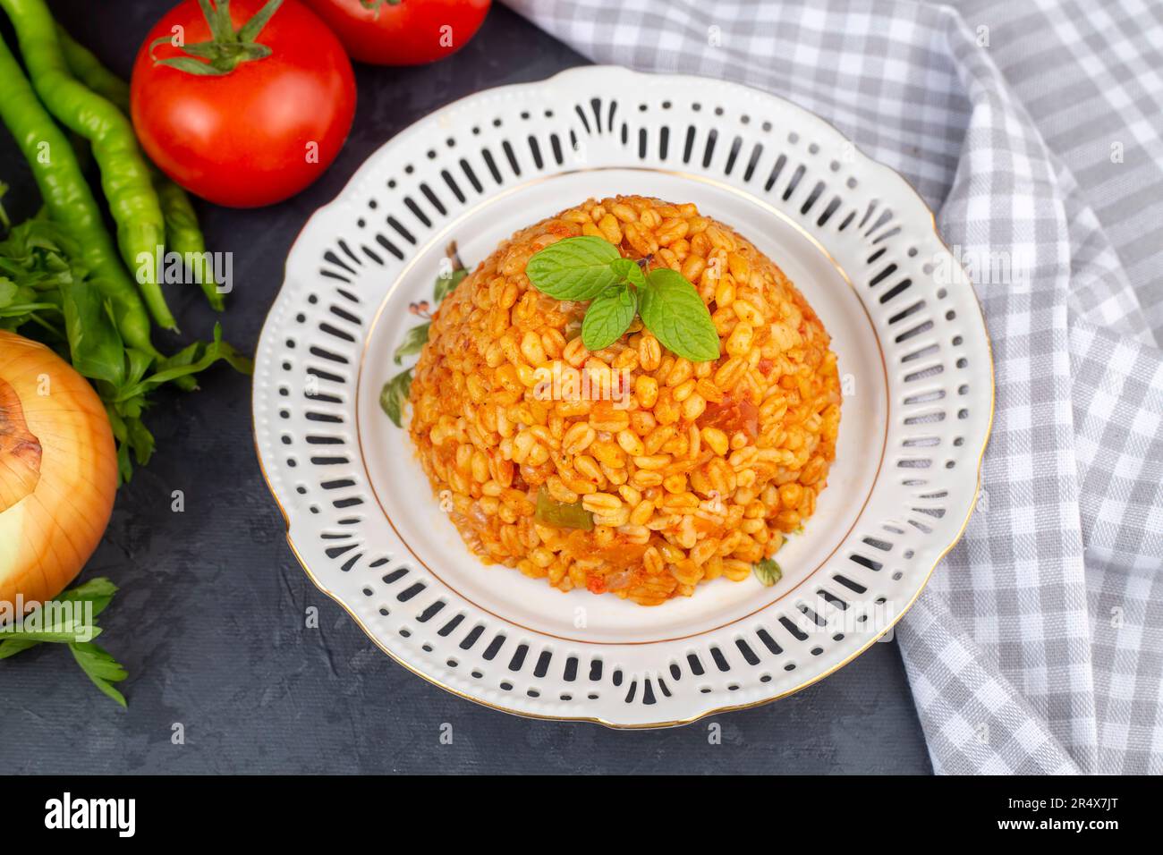 Traditional turkish bulgur pilaf with tomato sause in plate (Turkish ...