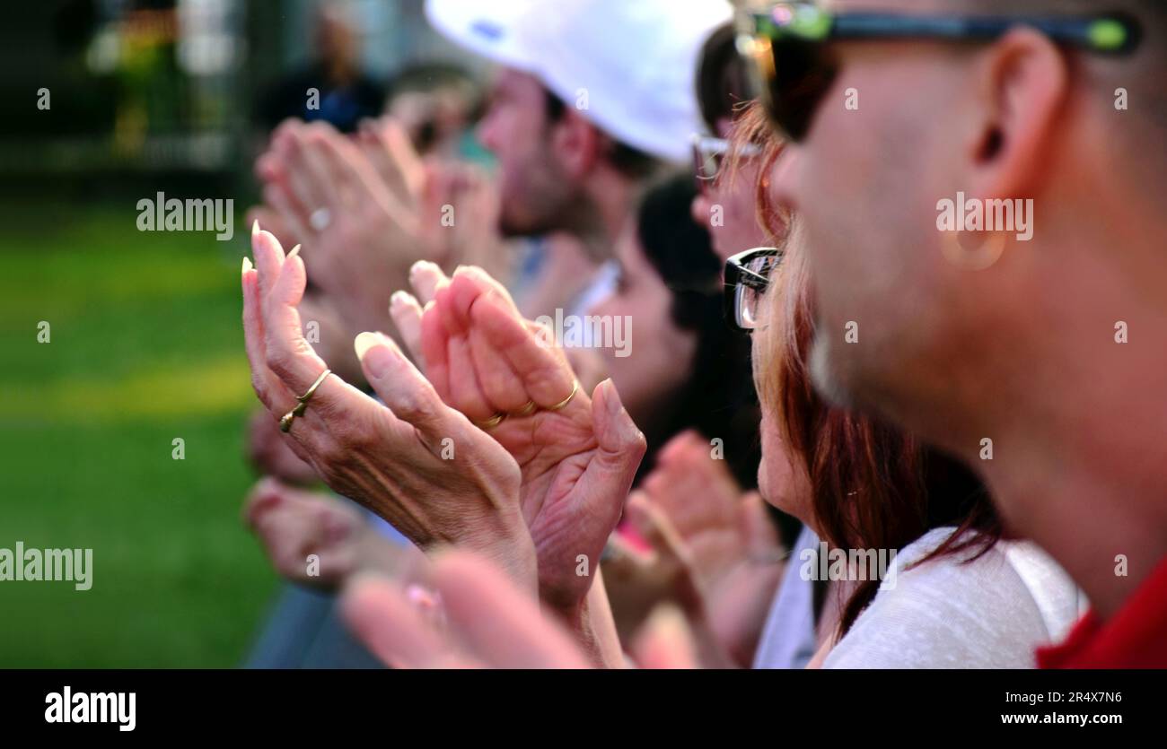 cheering and applauding blurred people at concert event. clapping ...