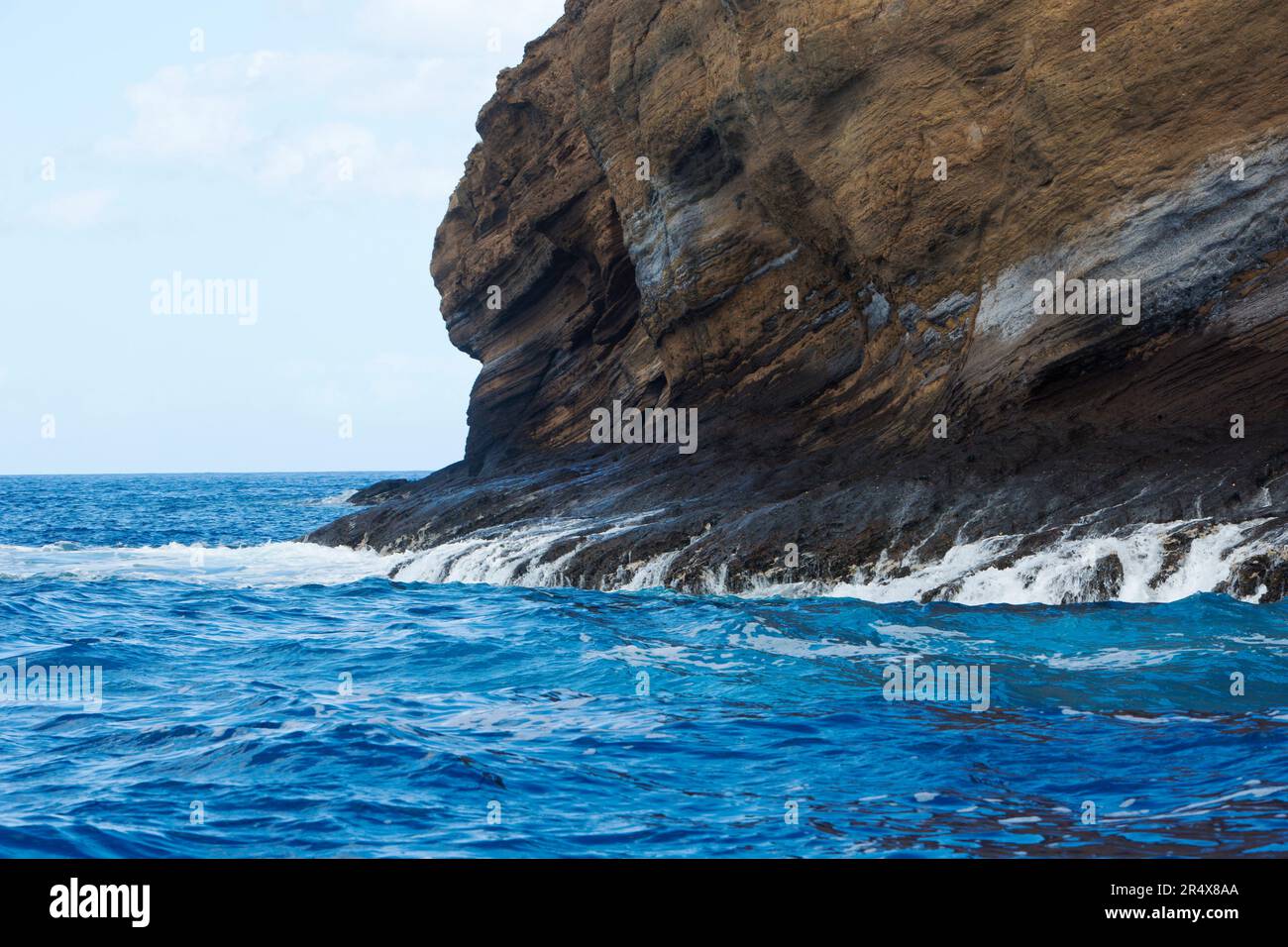 The sea, washing down the back side of the rock face of the crescent ...