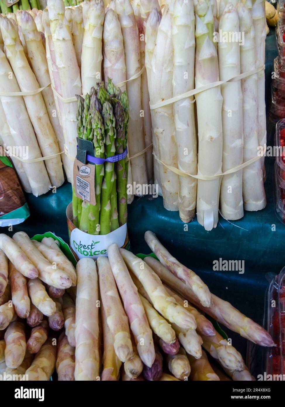 Close up food still life of white and green asparagus on sale in a ...
