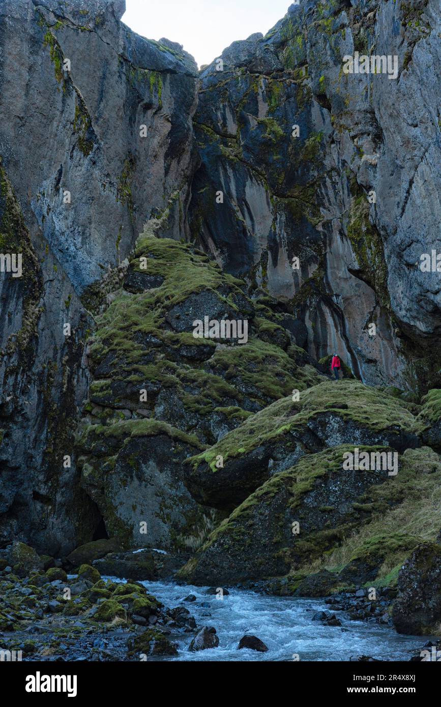 Woman exploring the canyons and scenery of Thorsmork, an area of ...