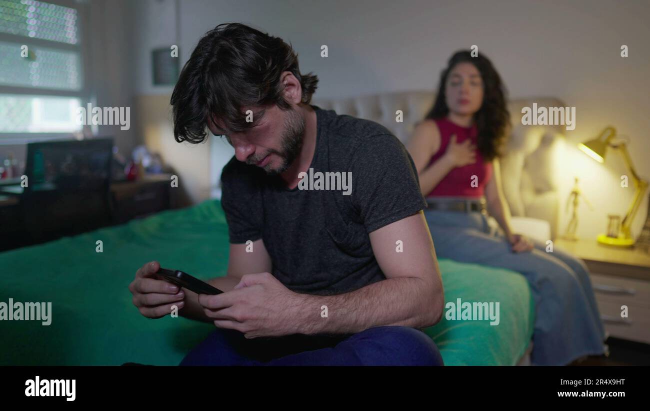 Disconnected couple Boyfriend looking at phone ignoring girlfriend by ...