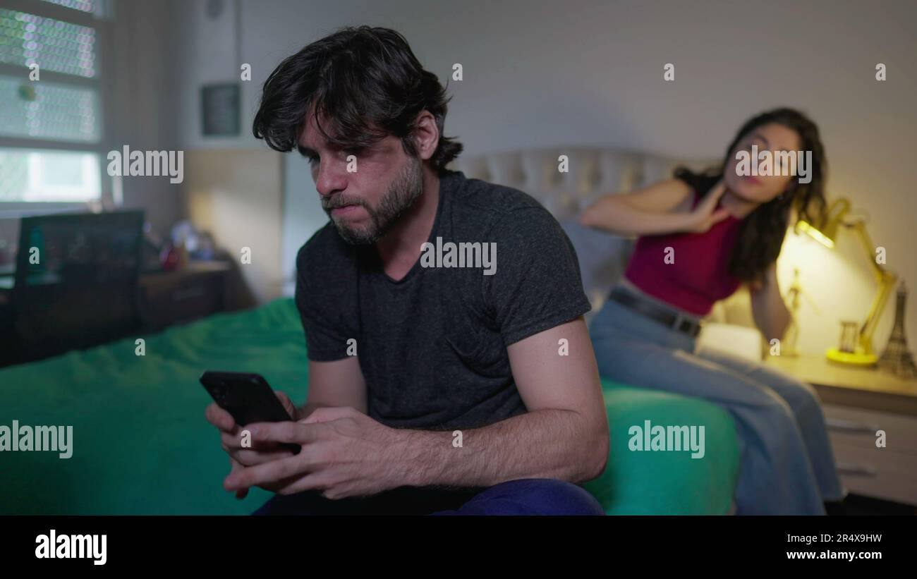 Disconnected couple Boyfriend looking at phone ignoring girlfriend by ...