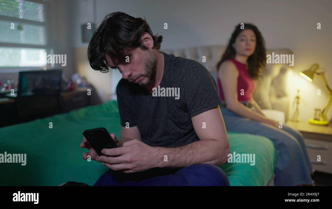 Disconnected couple Boyfriend looking at phone ignoring girlfriend by ...