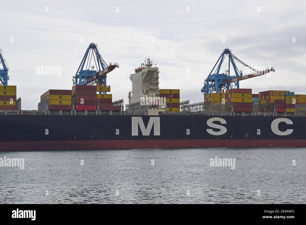 Harbour cranes unloading shipping containers from the MSC Vega ship ...