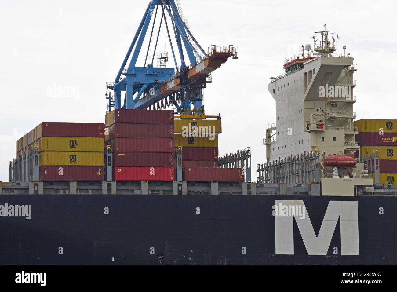 Harbour cranes unloading shipping containers from the MSC Vega ship ...