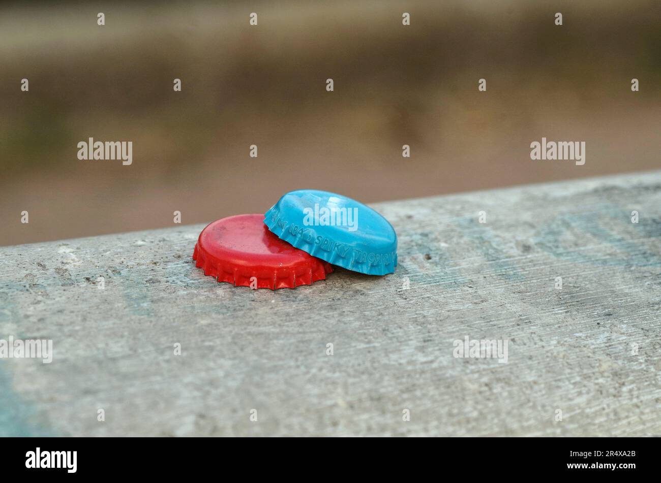 two colored bottle caps on the wall in focus on foreground Stock Photo ...