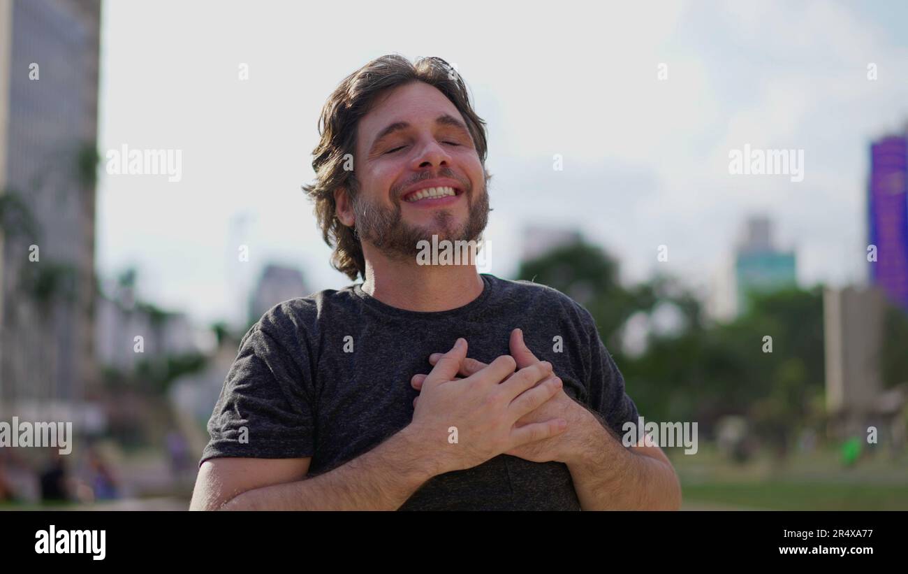 Exultant Young Man Expressing Hope and Faith with Uplifted Arms ...