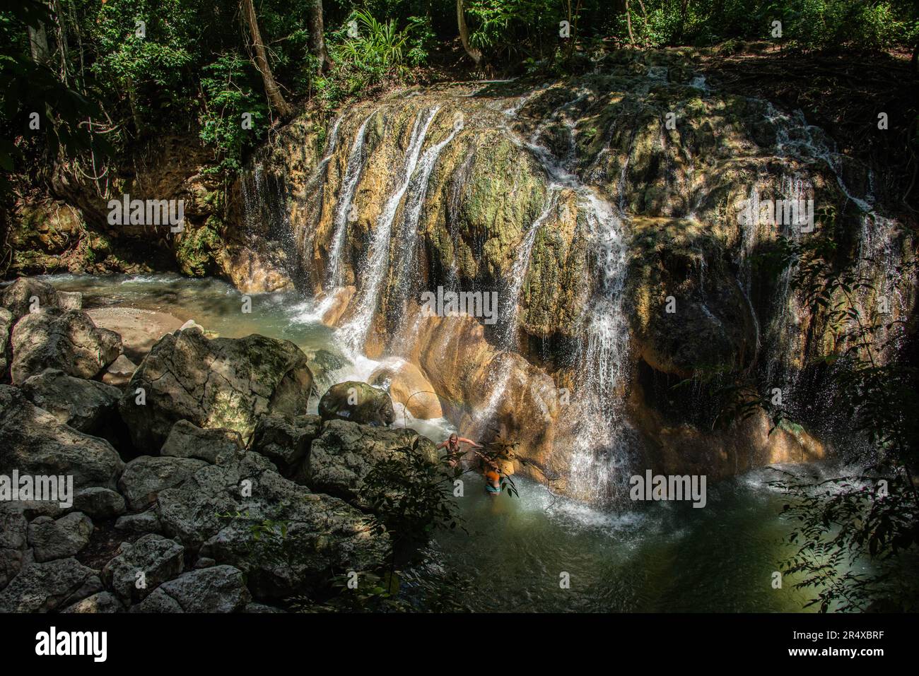 Enjoying the hot spring waterfall of Finca Paraiso, Rio Dulce ...
